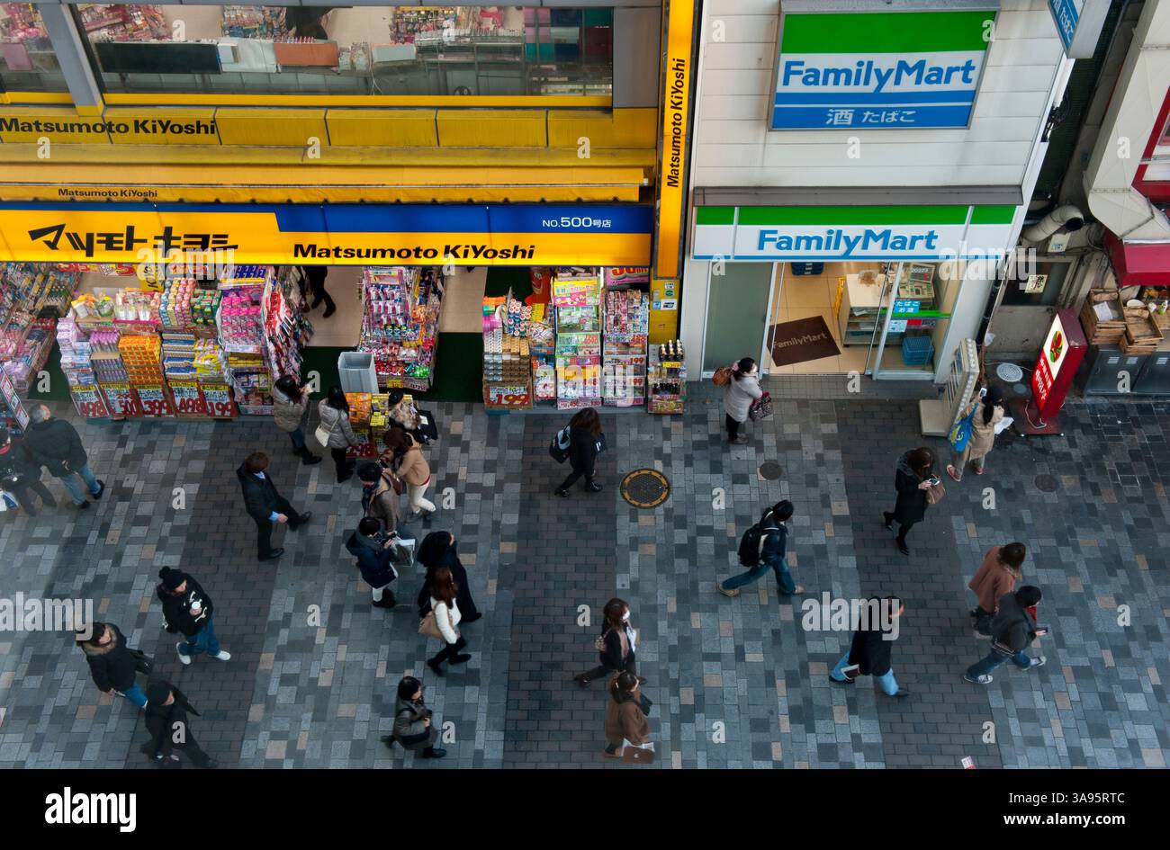 View from above a a typical street scene with pedestrians passing a ...