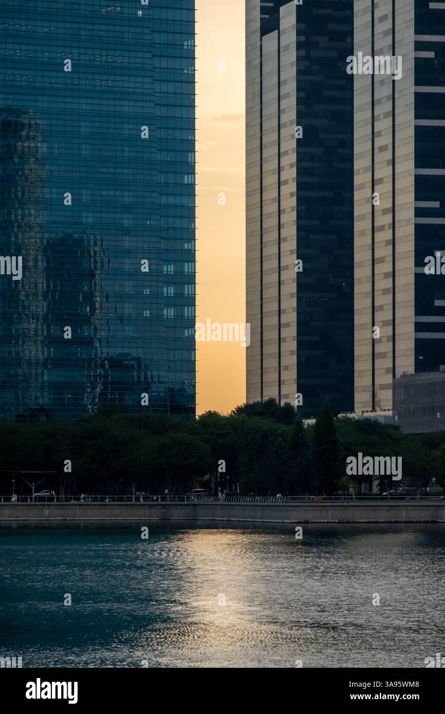 A beautiful sunset sky between two high-rise building Stock Photo - Alamy