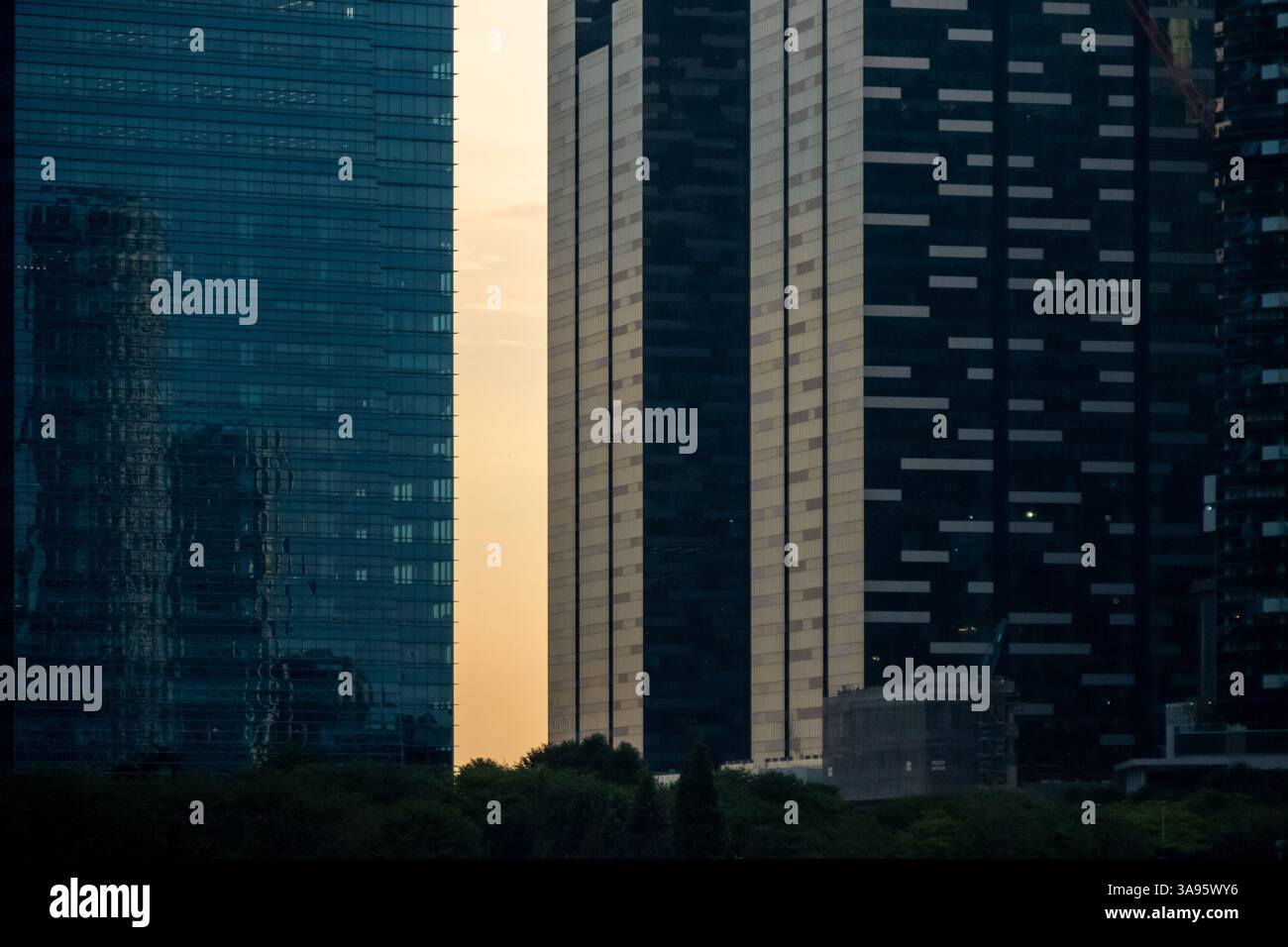 A beautiful sunset sky between two high-rise building Stock Photo - Alamy