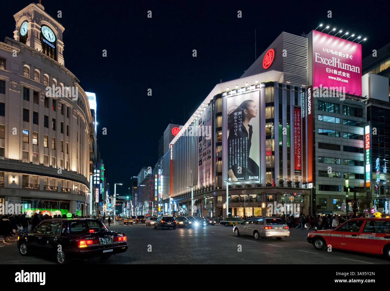 Night view of busy intersection of Chuo-dori and Harumi-dori streets ...