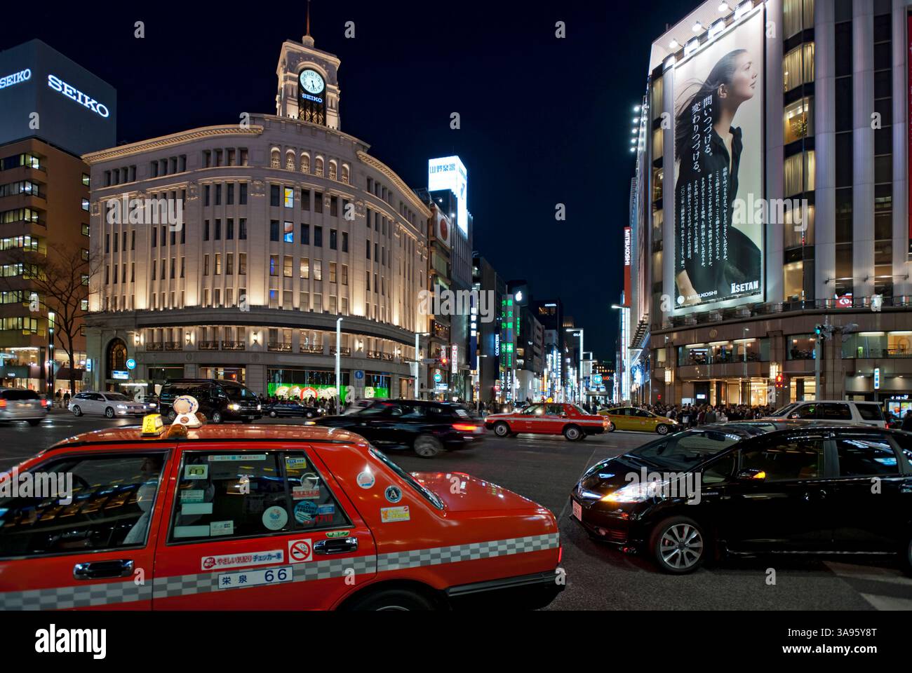 Night view of busy intersection of Chuo-dori and Harumi-dori streets ...