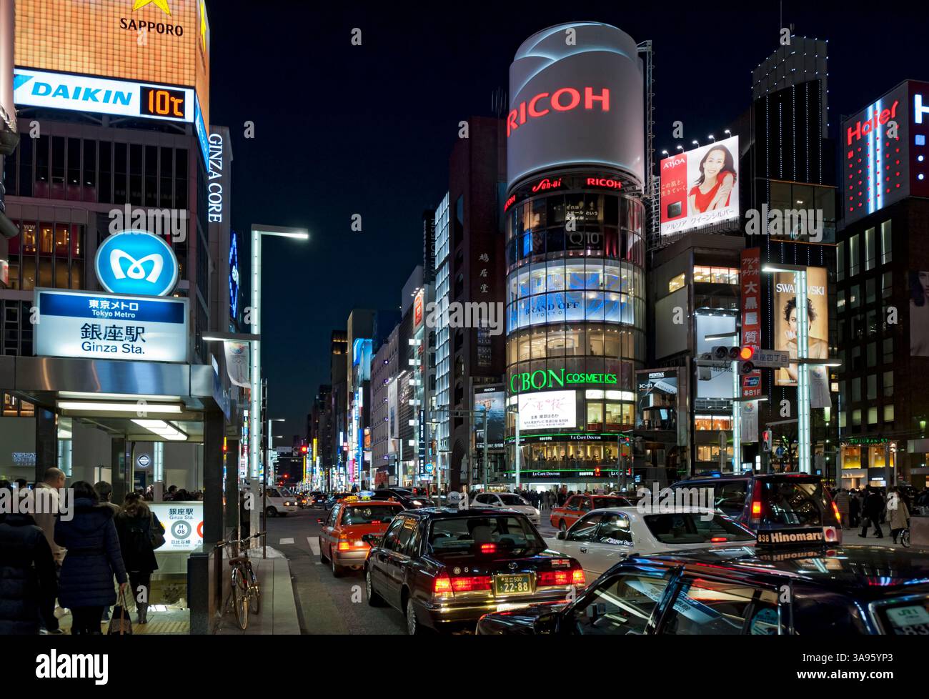 Night view of busy intersection of Chuo-dori and Harumi-dori streets ...