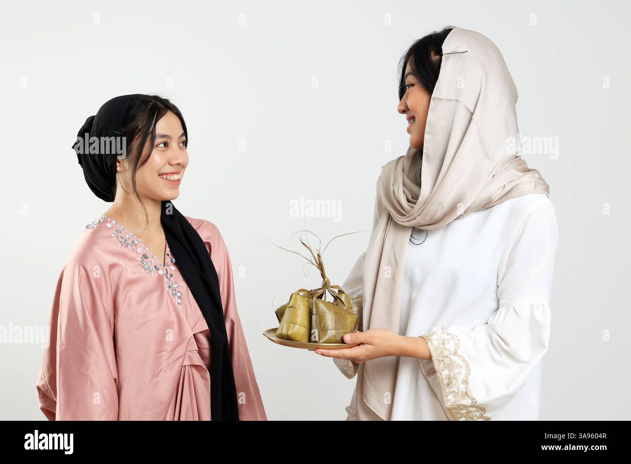 Two Female Sharing Ketupat, Indonesian Rice Cake Popular for Eid Al ...