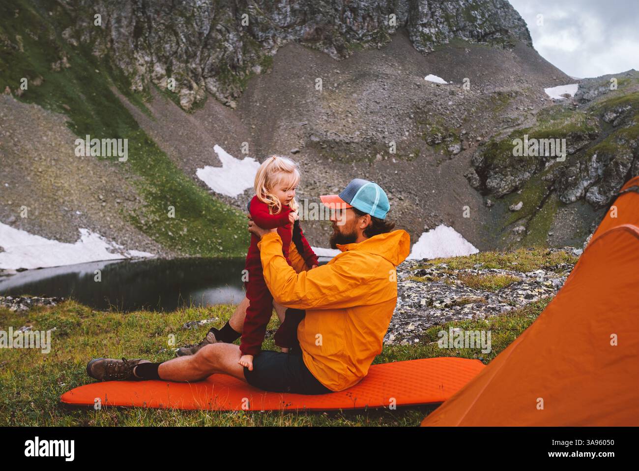 Family camping - father playing with daughter in mountains, parent ...