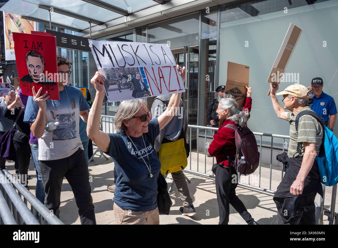 Protesters block an entrance to the Manhattan Tesla showroom during a ...