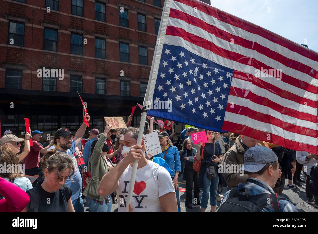 New York, United States. 29th Mar, 2025. A protester holds an upside ...