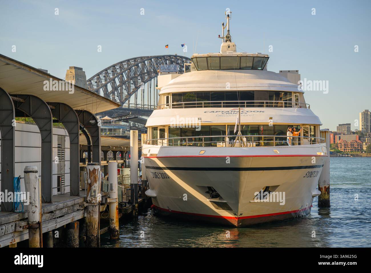 A Captain Cook Cruises boat docked at Circular Quay with the Sydney ...