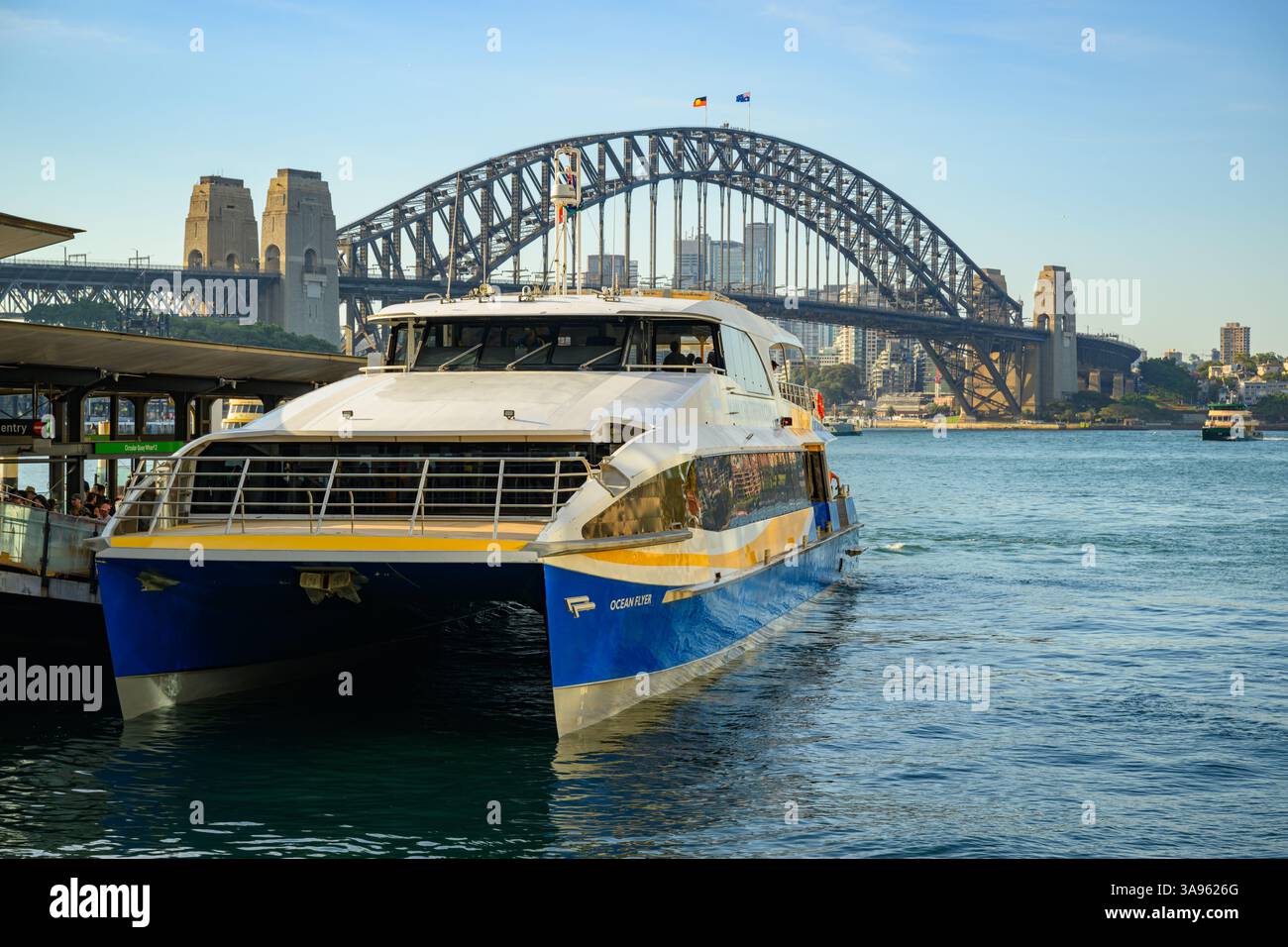 A Manly Fast Ferry boat docked at Circular Quay with the Sydney Harbour ...