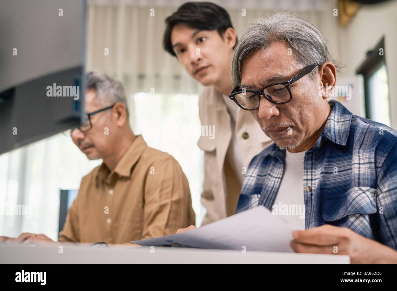 Group of asian senior in a collaborative software development analyzing ...