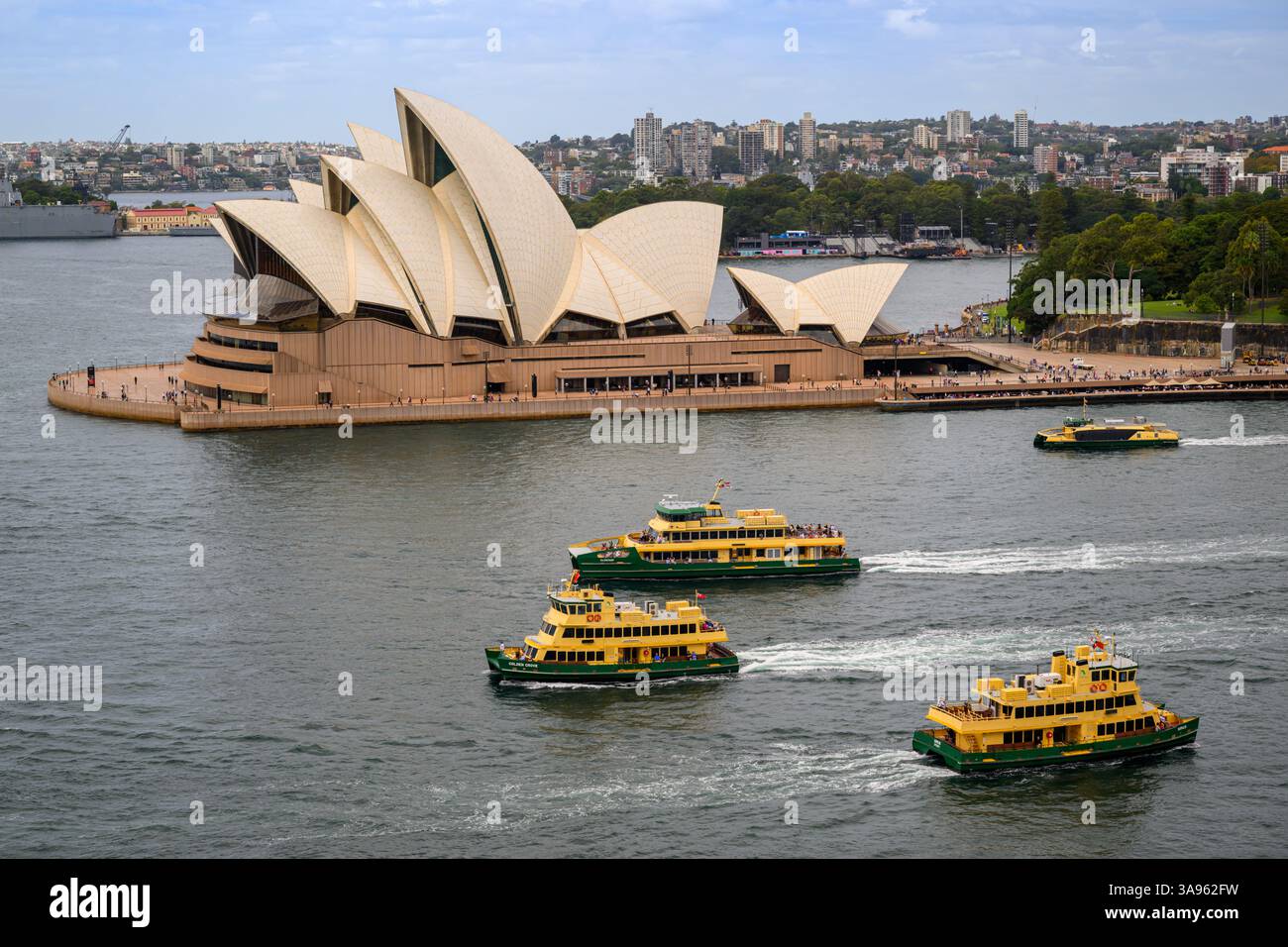 Looking down on the Sydney Opera House with four Sydney Harbour Ferries ...