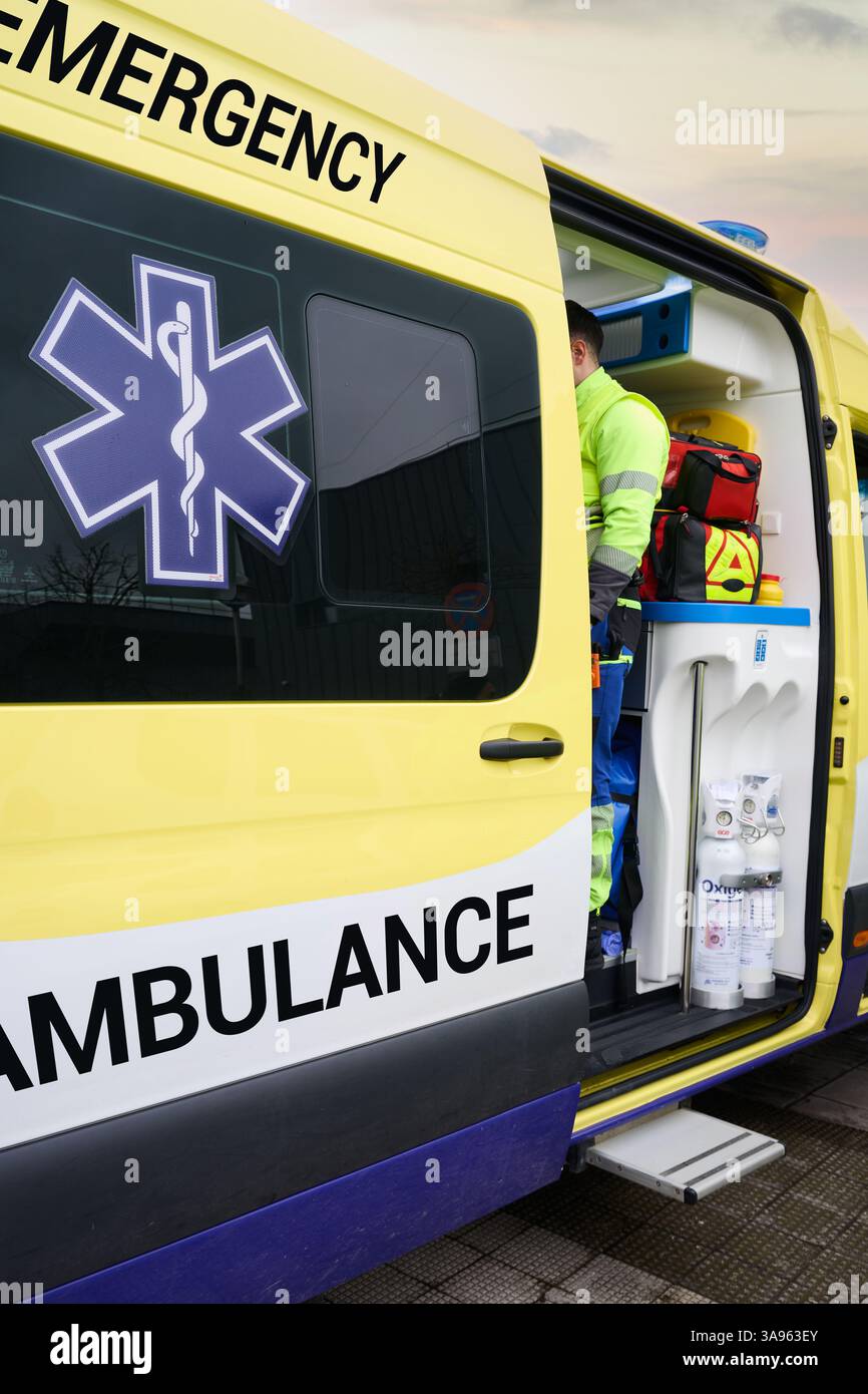 Close-up view of a yellow emergency ambulance with an open side door ...
