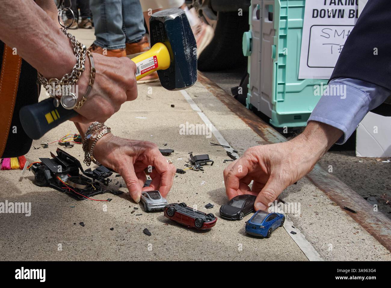 Manhattan, United States. 29th Mar, 2025. People smash a toy Telsa cars ...