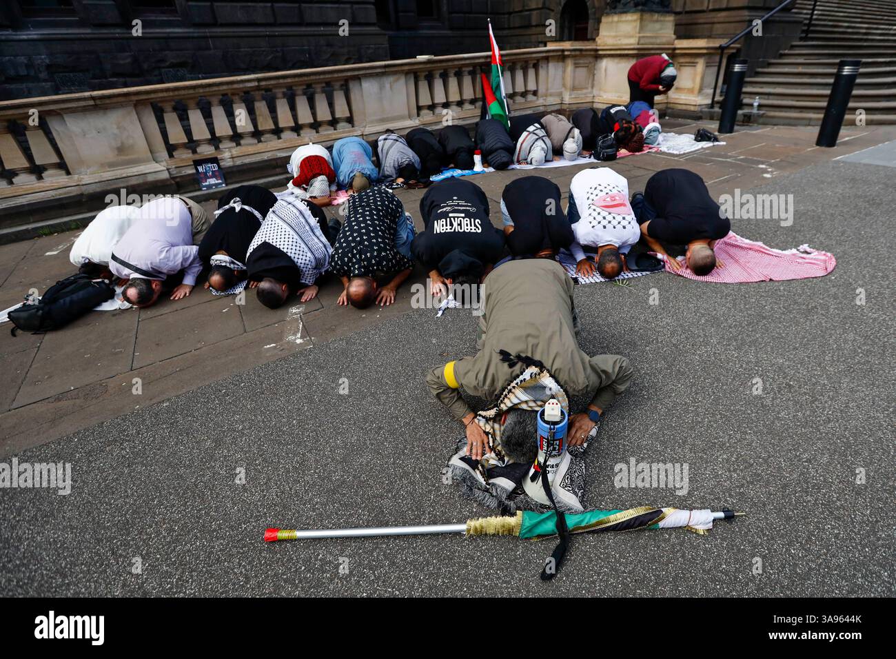Protesters pray Salah (Islamic prayer) after the rally. Protesters ...
