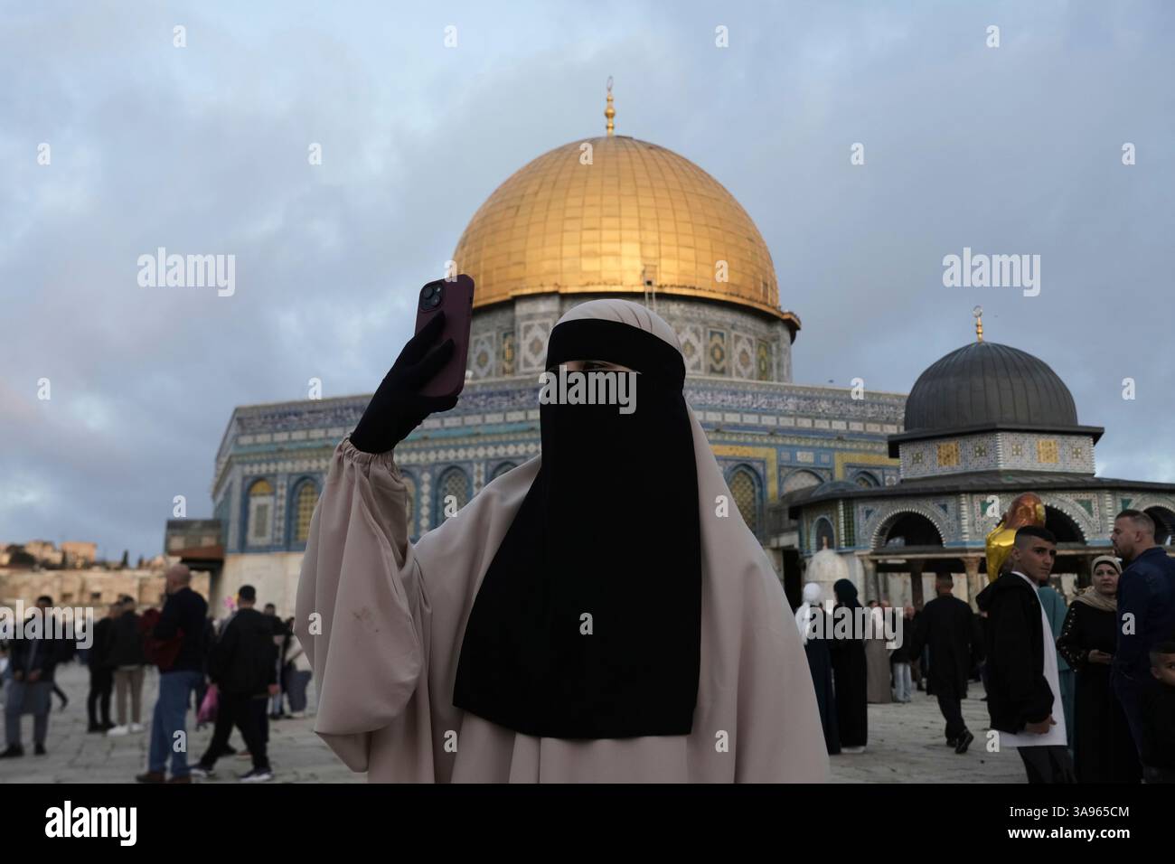 Palestinians attend Eid al-Fitr holiday celebrations by the Dome of the ...
