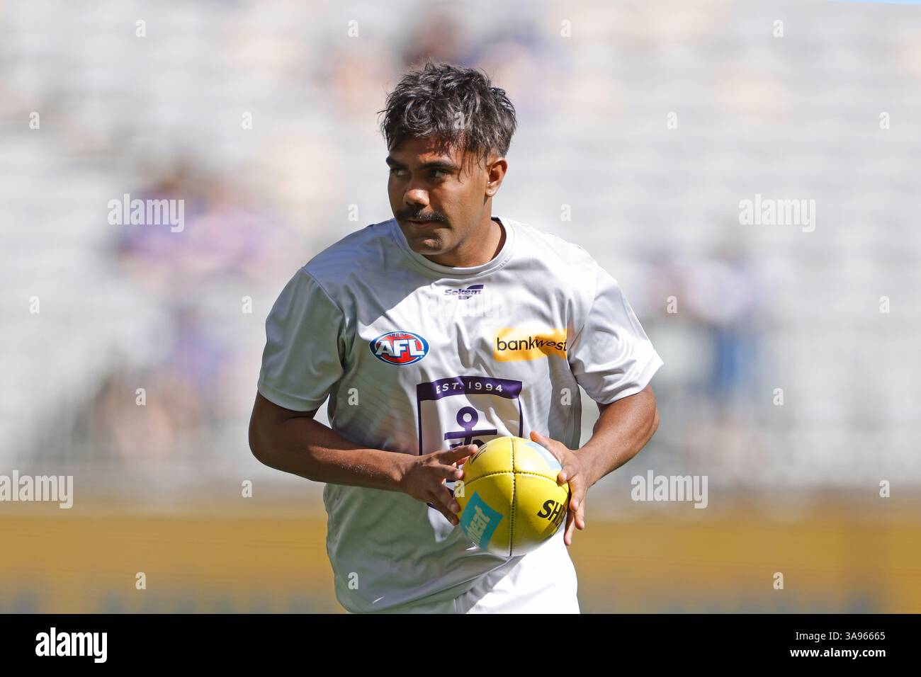Isaiah Dudley of the Dockers is seen warming up before the AFL Round 3 ...
