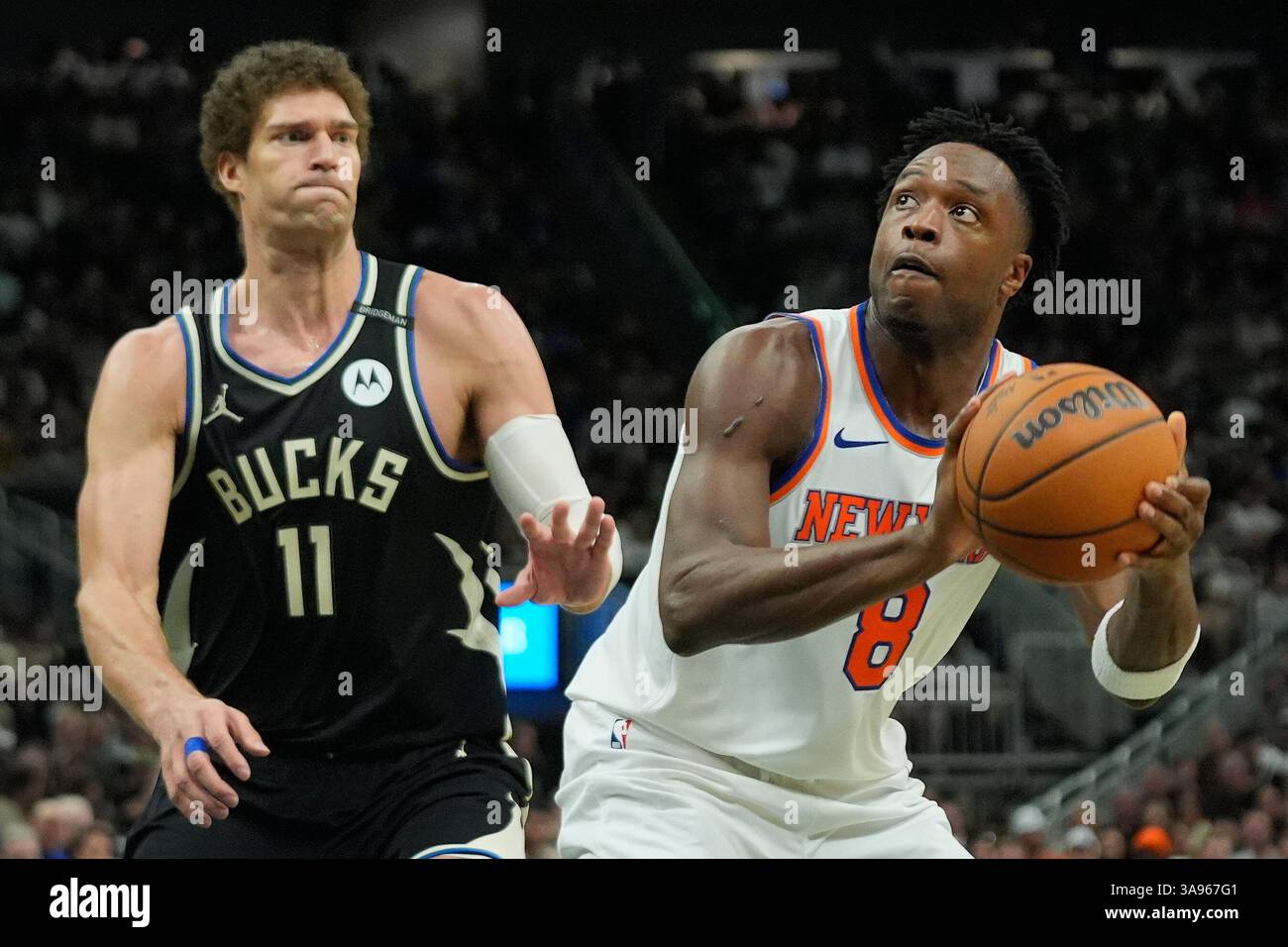 New York Knicks' OG Anunoby looks to shoot against Milwaukee Bucks' Brook Lopez during the first ...