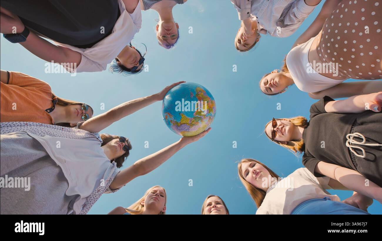 School friends joining hands around a globe, representing their ...