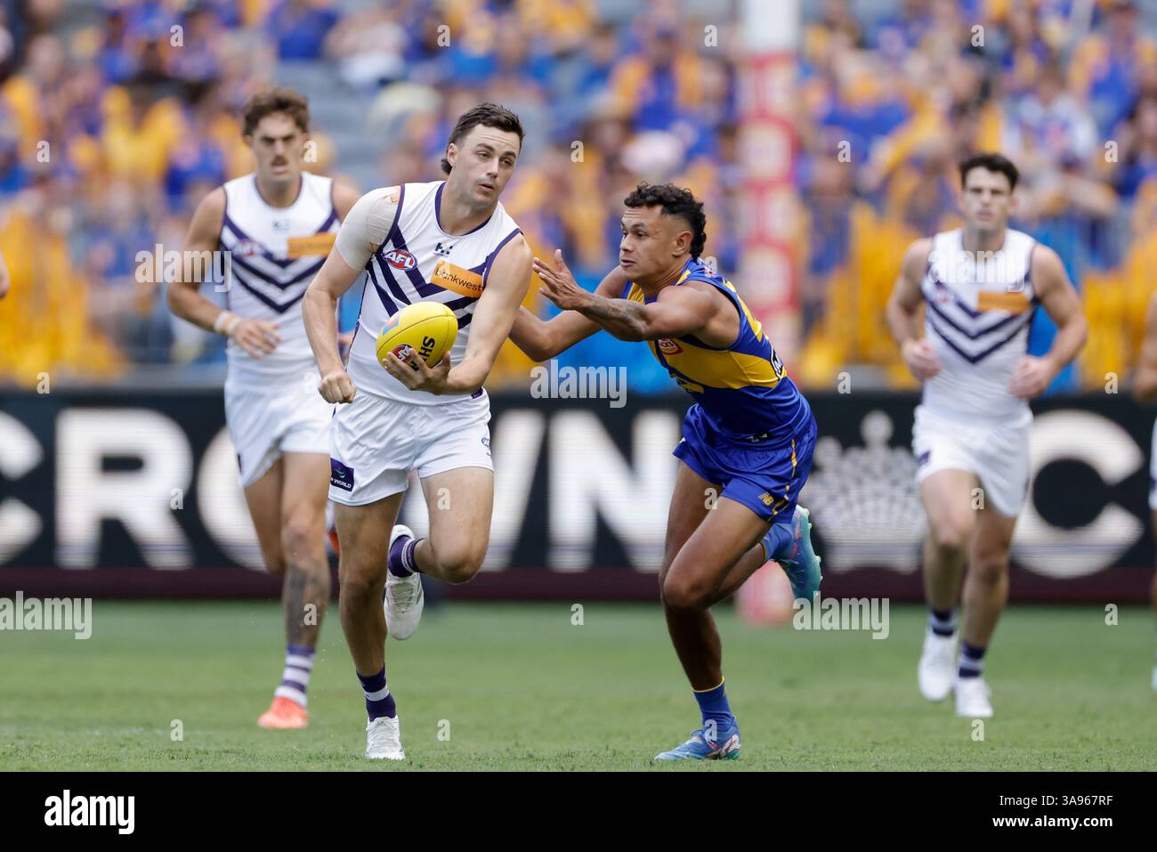Perth, Australia. 30th Mar, 2025. Jordan Clark of the Dockers handballs ...