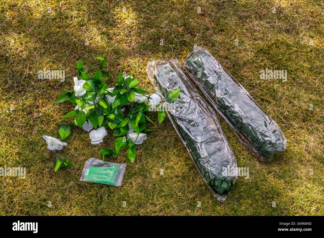 Preparing for the installation of artificial leaf netting on a fence ...