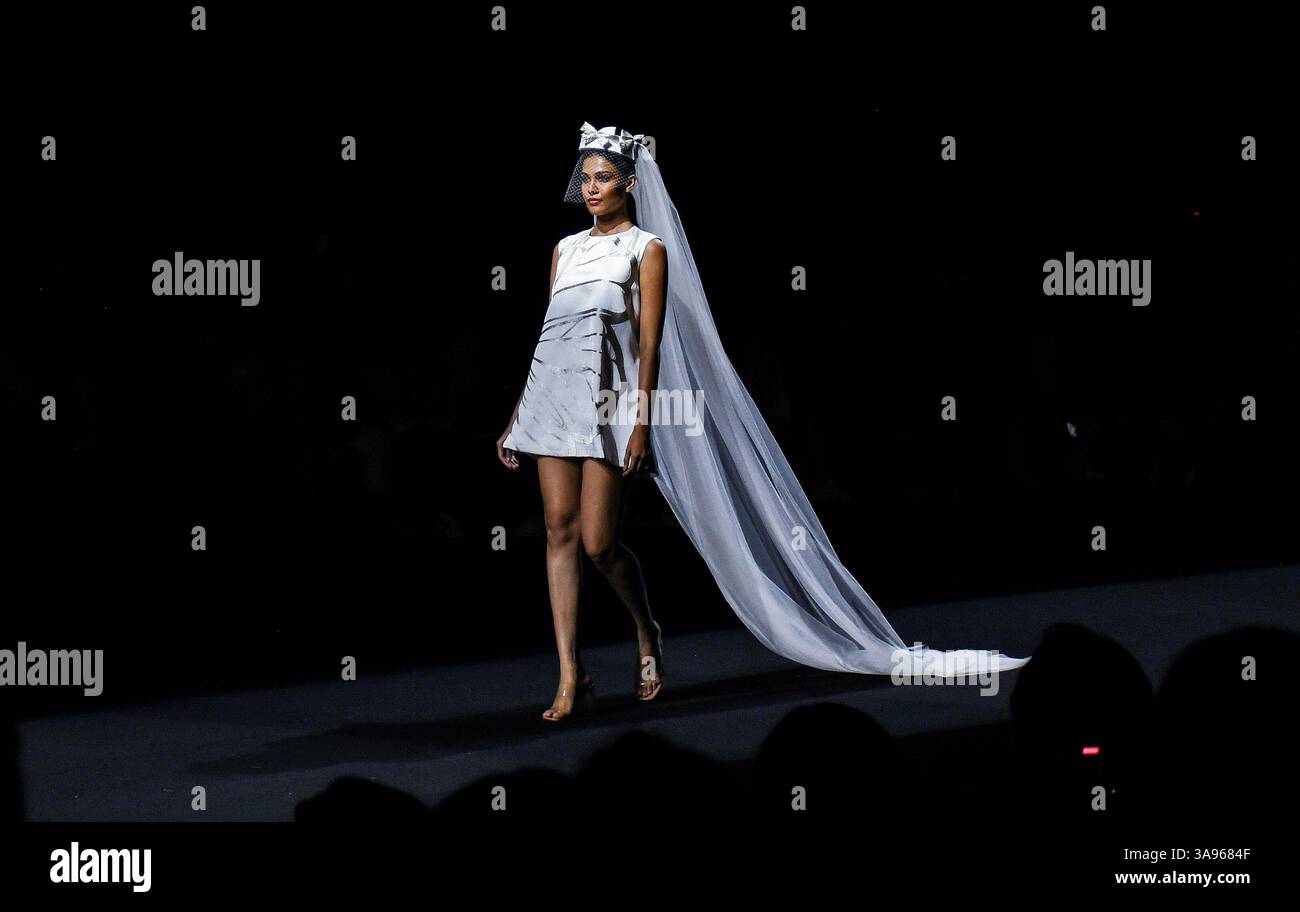 A model wearing creation by designer Salim Azzam walks on the ramp on ...