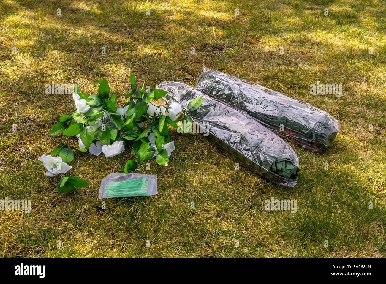 Preparing for the installation of artificial leaf netting on a fence ...
