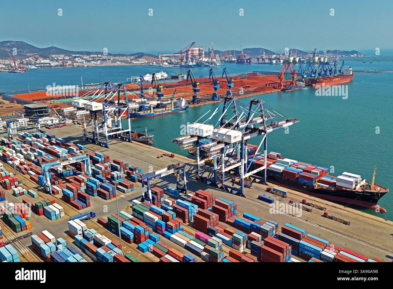 YANTAI, CHINA - MARCH 30, 2025 - A cargo ship loads containers at the ...