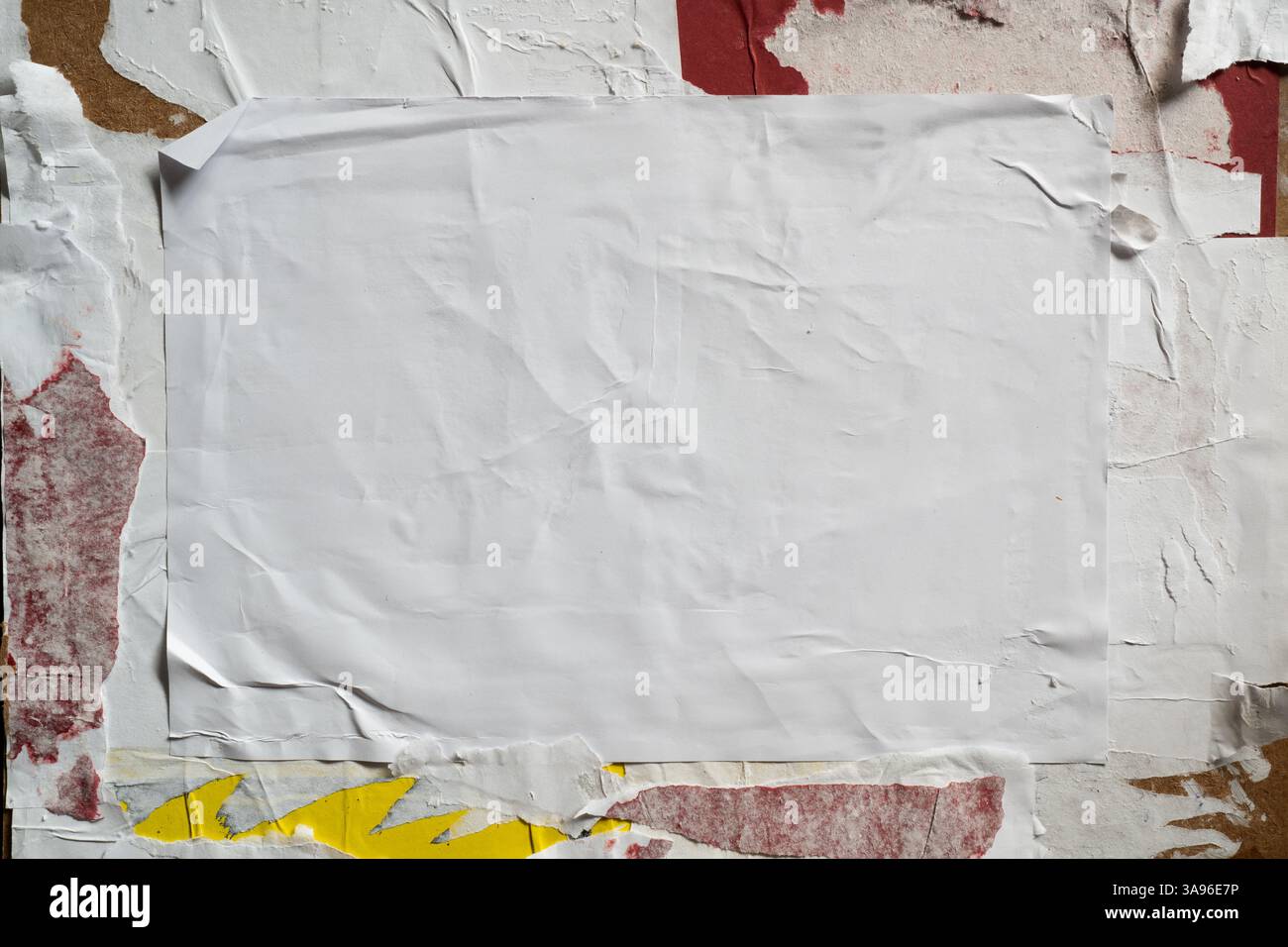 Wheatpaste poster style texture on a dirty wall Stock Photo - Alamy