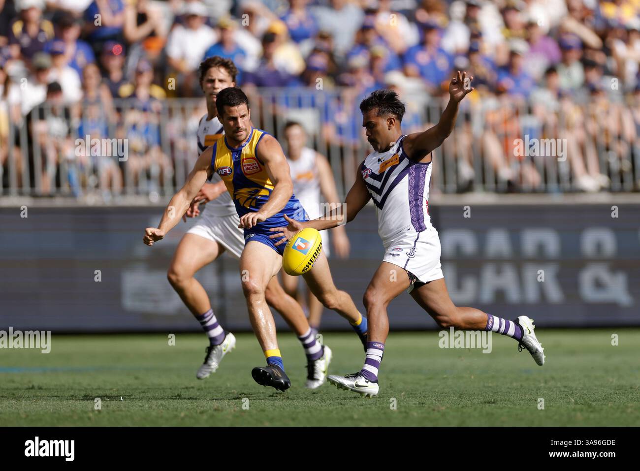 Perth, Australia. 30th Mar, 2025. Isaiah Dudley of the Dockers kicks a ...