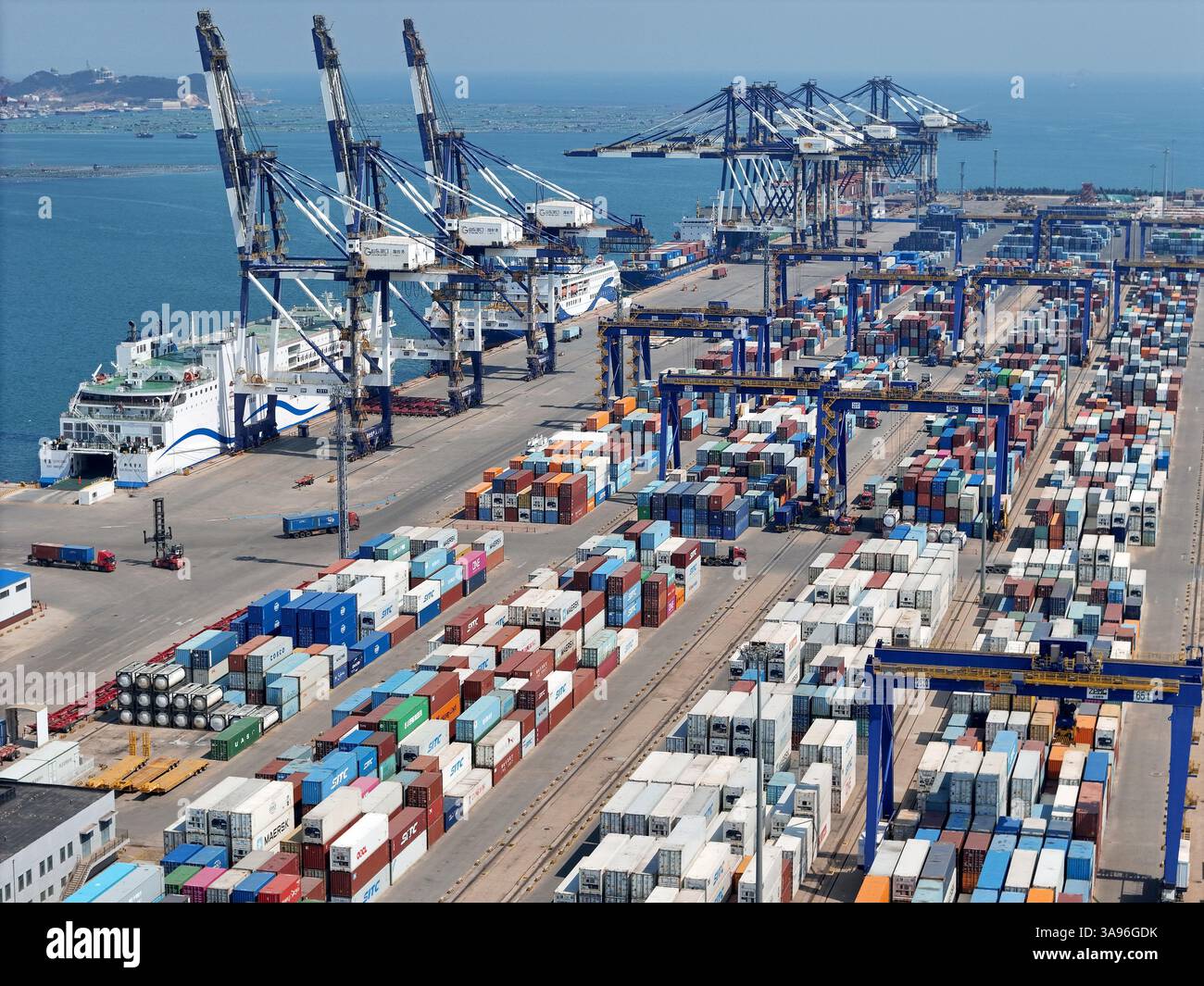 YANTAI, CHINA - MARCH 30, 2025 - A cargo ship loads containers at the ...