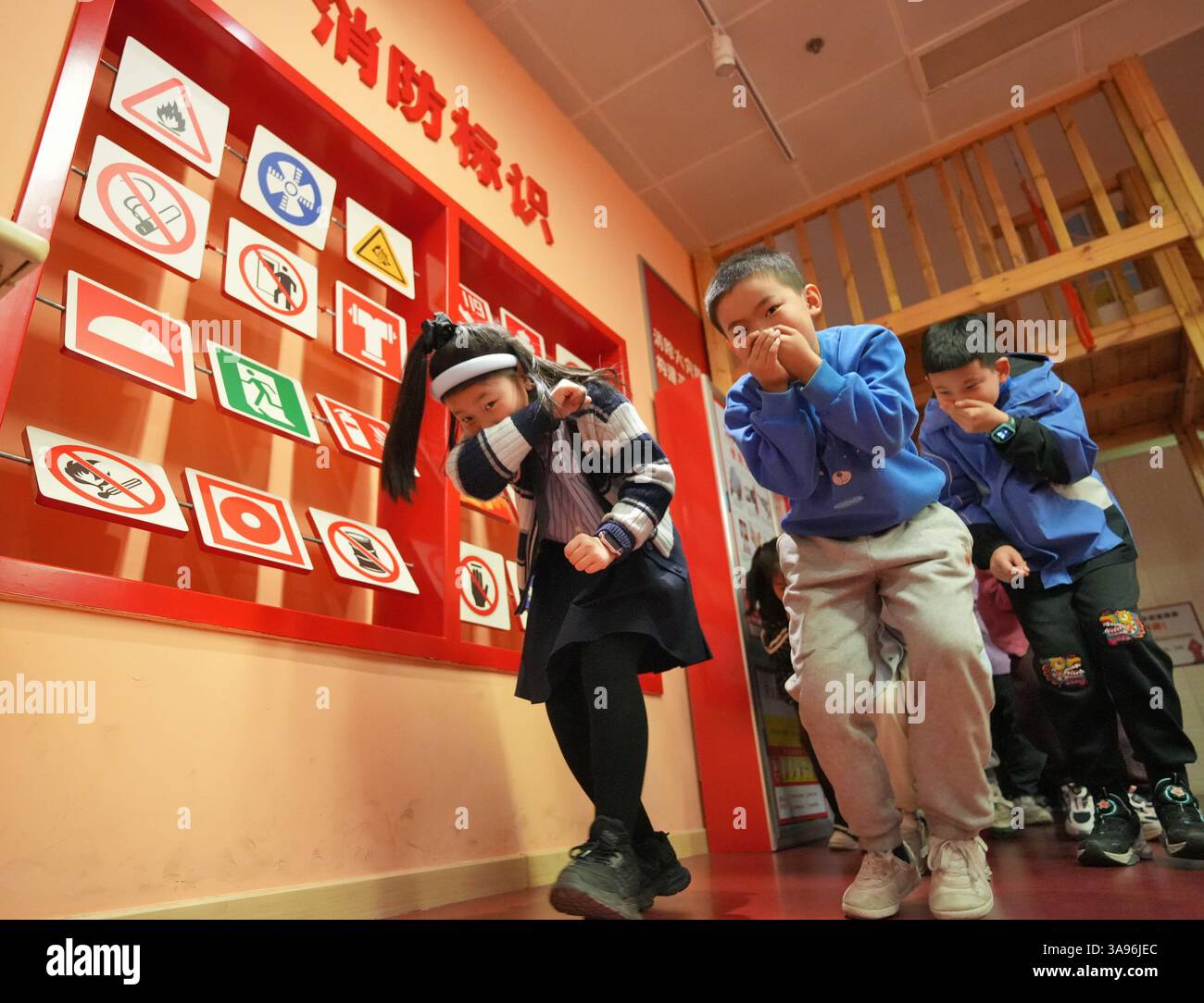 Primary school students conduct a fire evacuation drill at the Youth ...