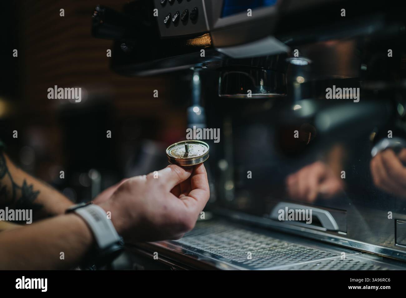 Barista Checking Espresso Machine in a Cafe Setting Stock Photo - Alamy