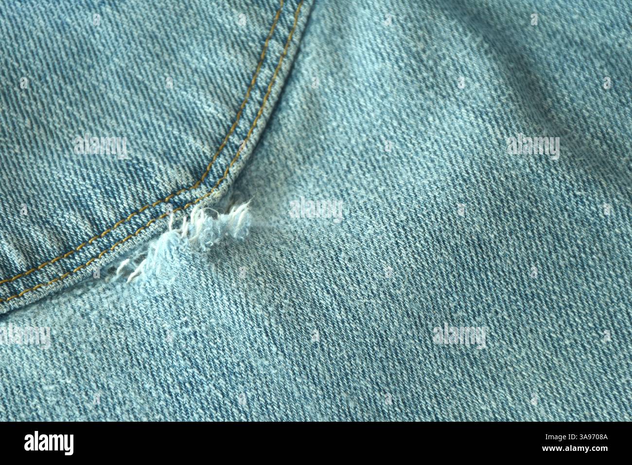 tear on back pocket jean fabric texture and background Stock Photo - Alamy