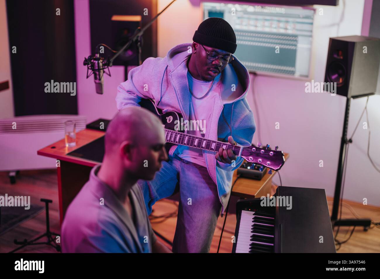 Talented musicians collaborating on music production in a modern ...