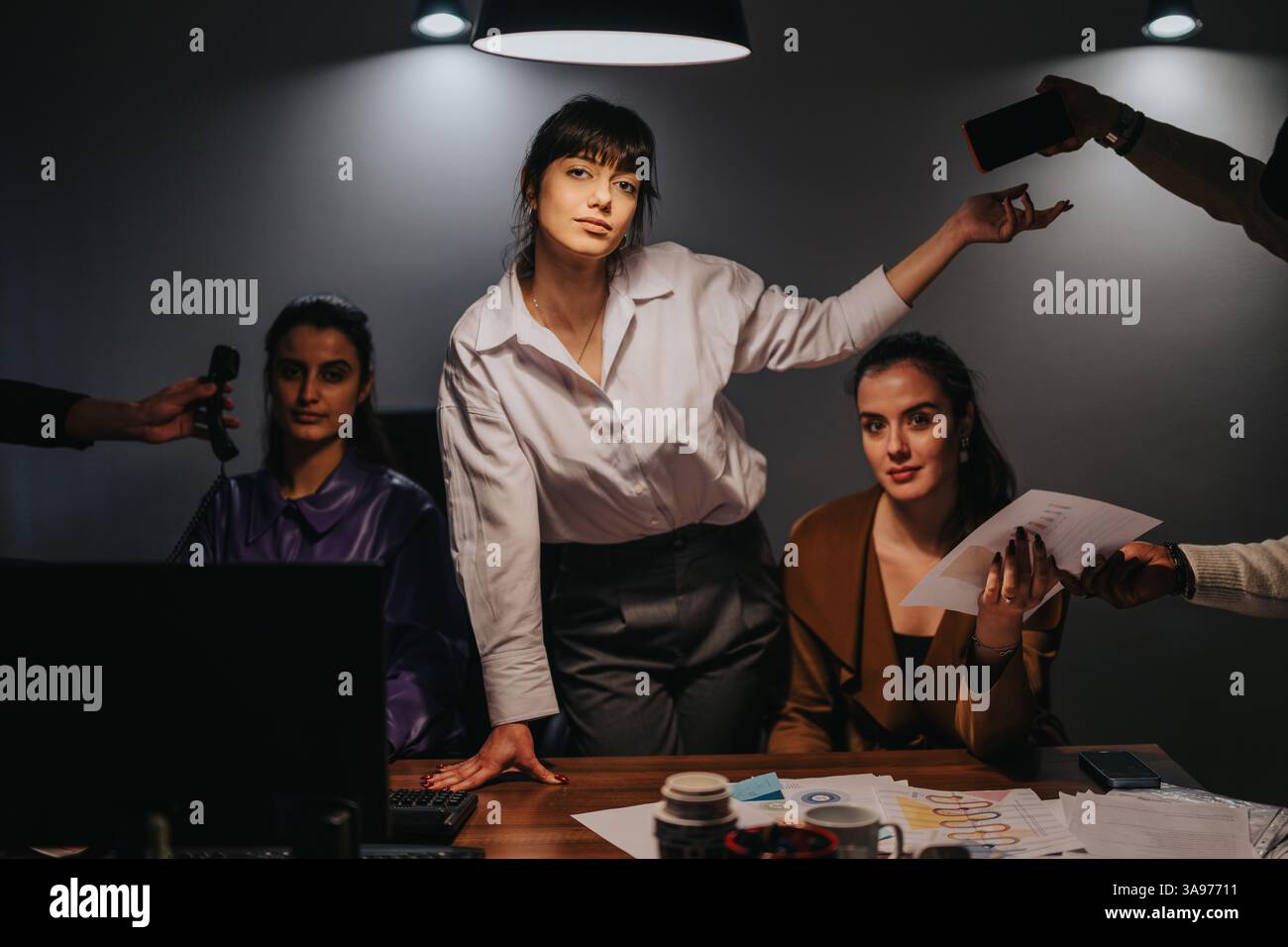 Female professionals collaborating in an office during a busy work ...