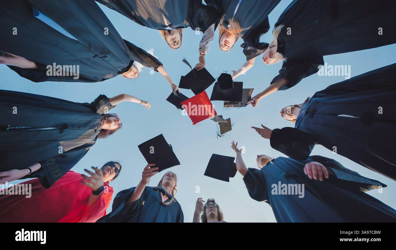 Cheerful graduates celebrating the end of an era and the beginning of a ...