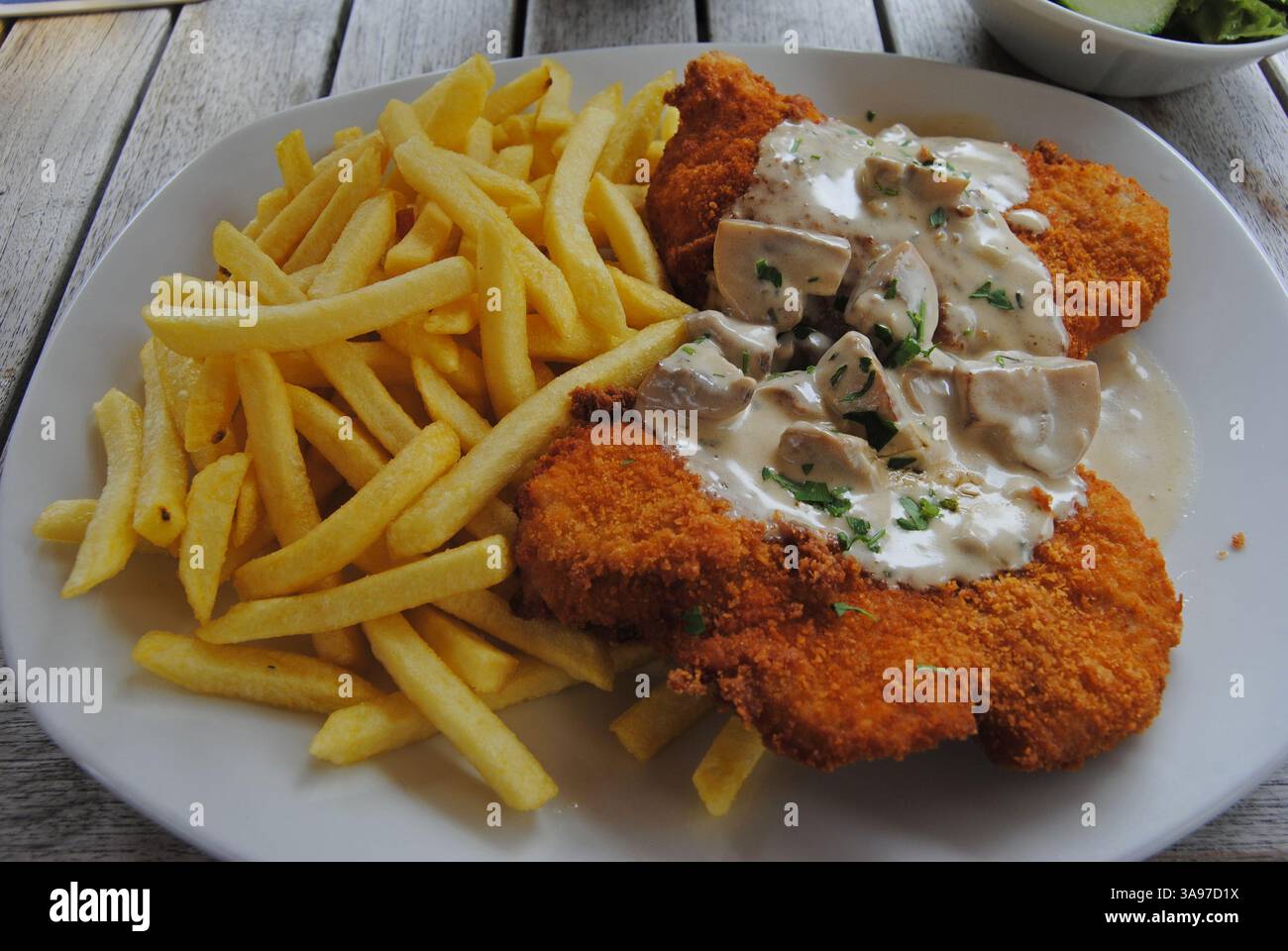 Schnitzel with mushroom sauce and french fries in Germany Stock Photo ...
