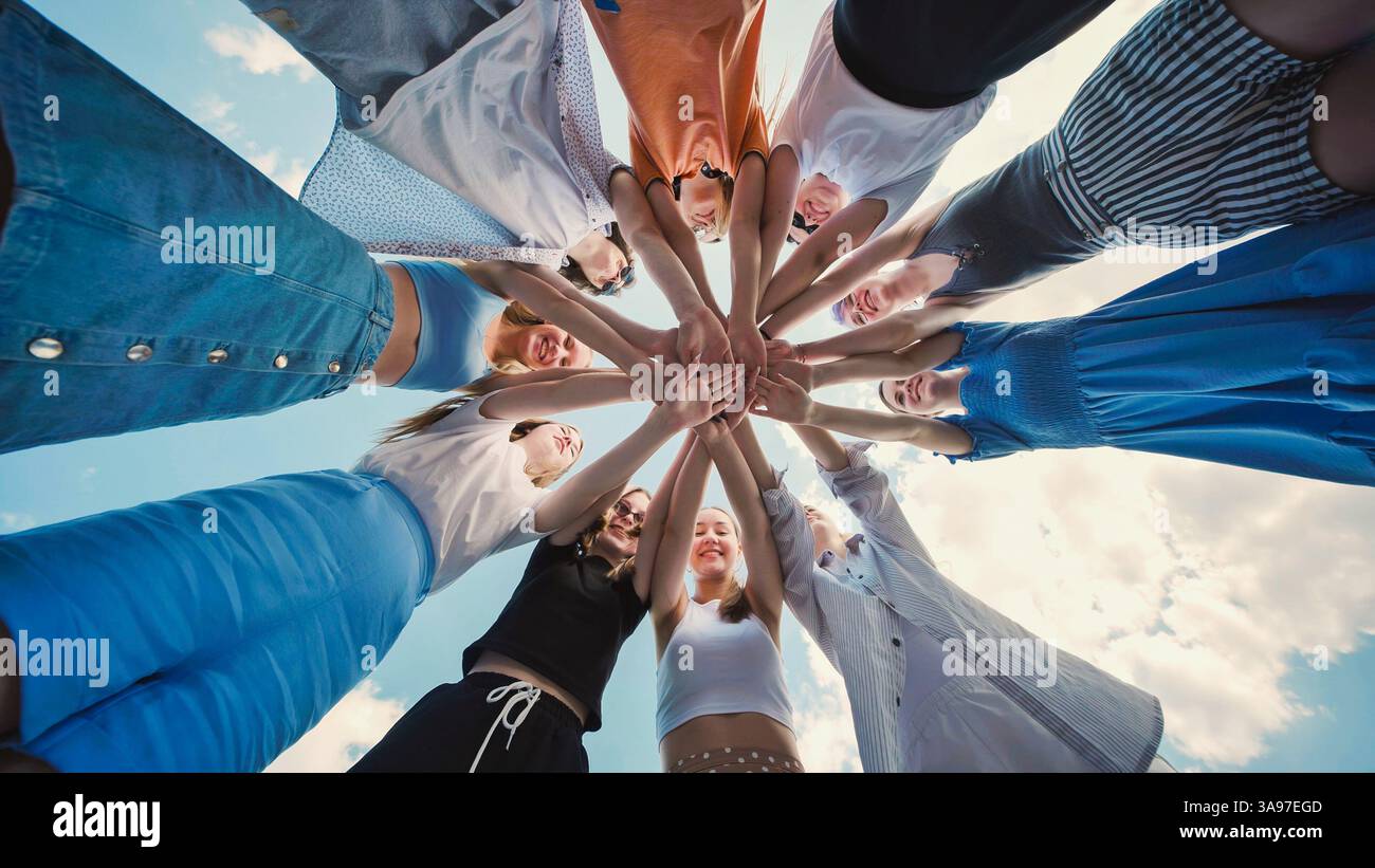 School friends joining hands in a circle, showcasing their unity, teamwork, and strong bond with ...