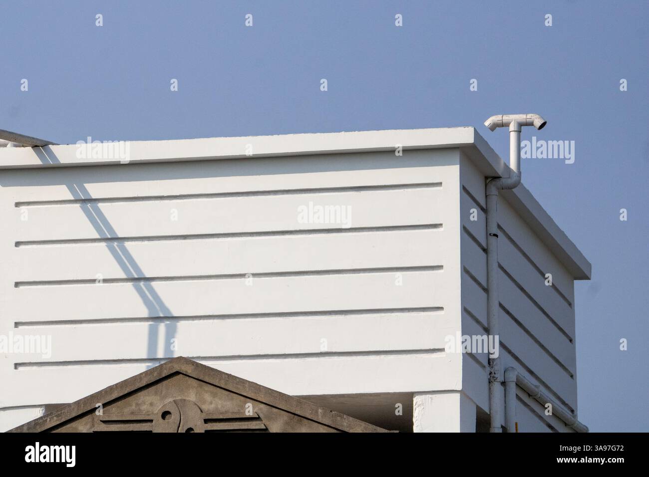 White rooftop water tank with geometric design, front-facing structure ...