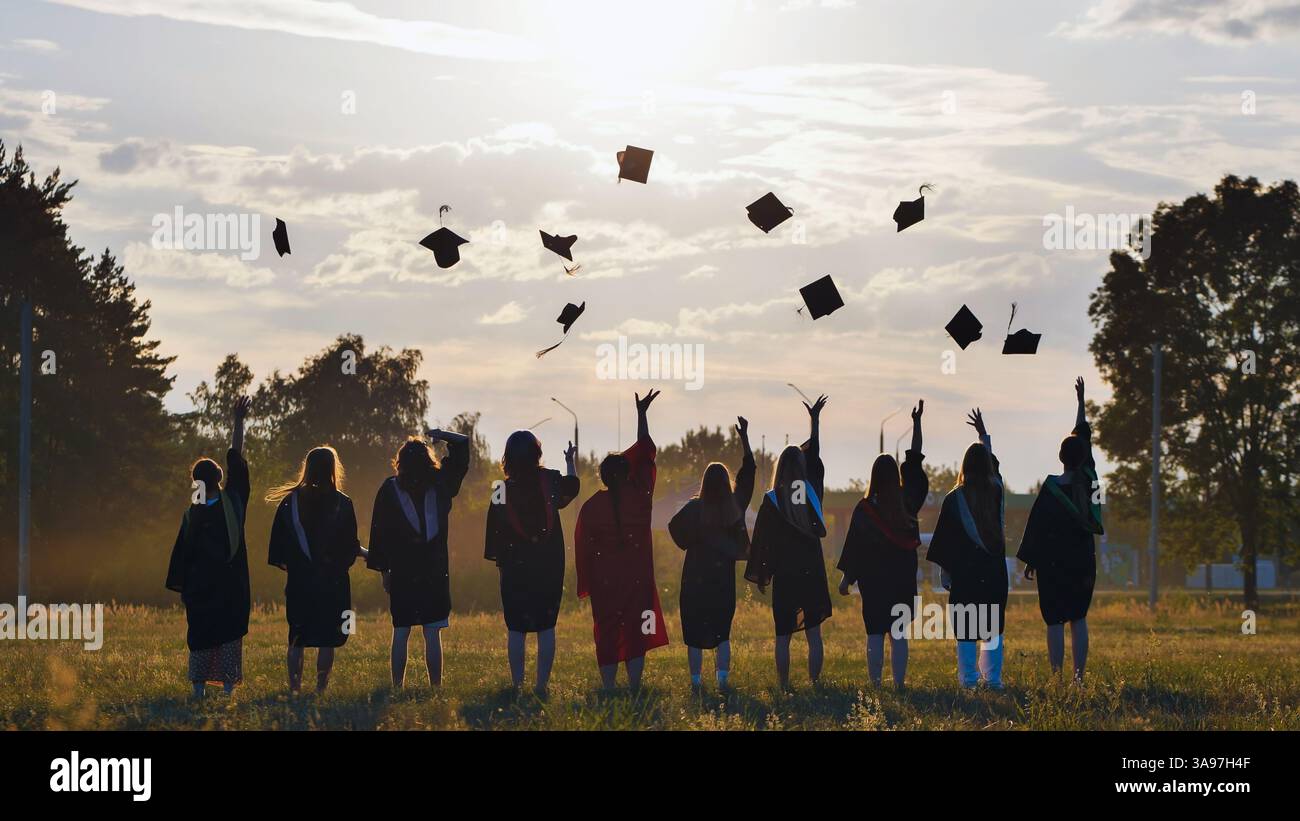 Group of students throwing their graduation caps in the air celebrating ...