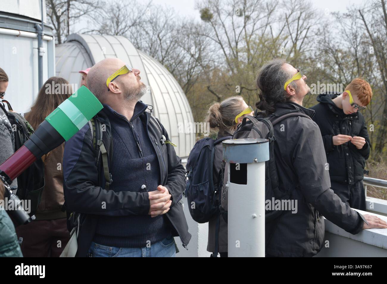 Berlin, Germany - March 28, 2025 - People watching a partial solar ...