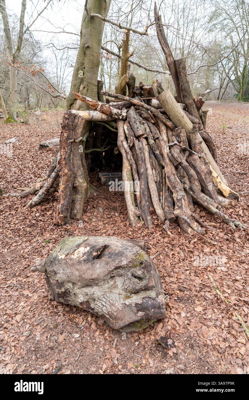 Bushcraft type shelter made of logs in woodland Stock Photo - Alamy