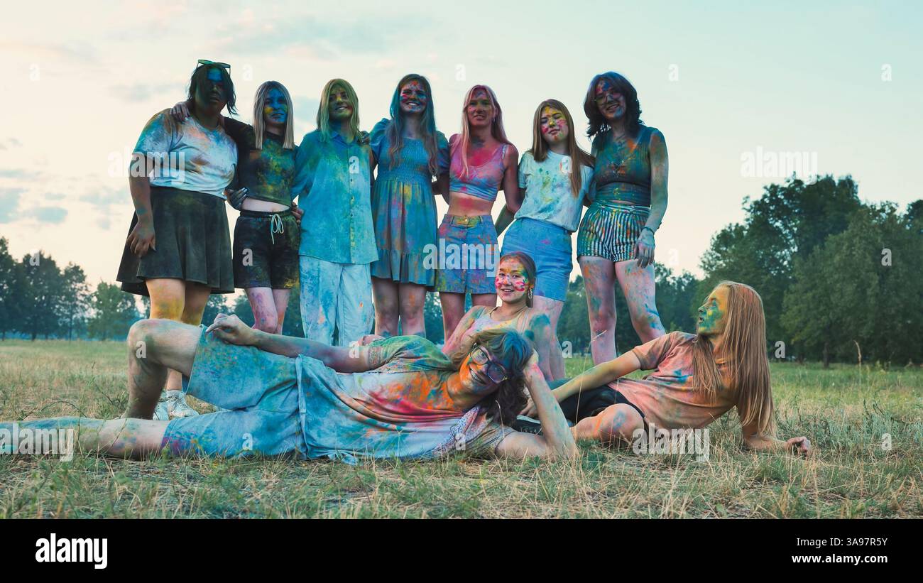 School friends having a blast with colorful holi powder during a ...