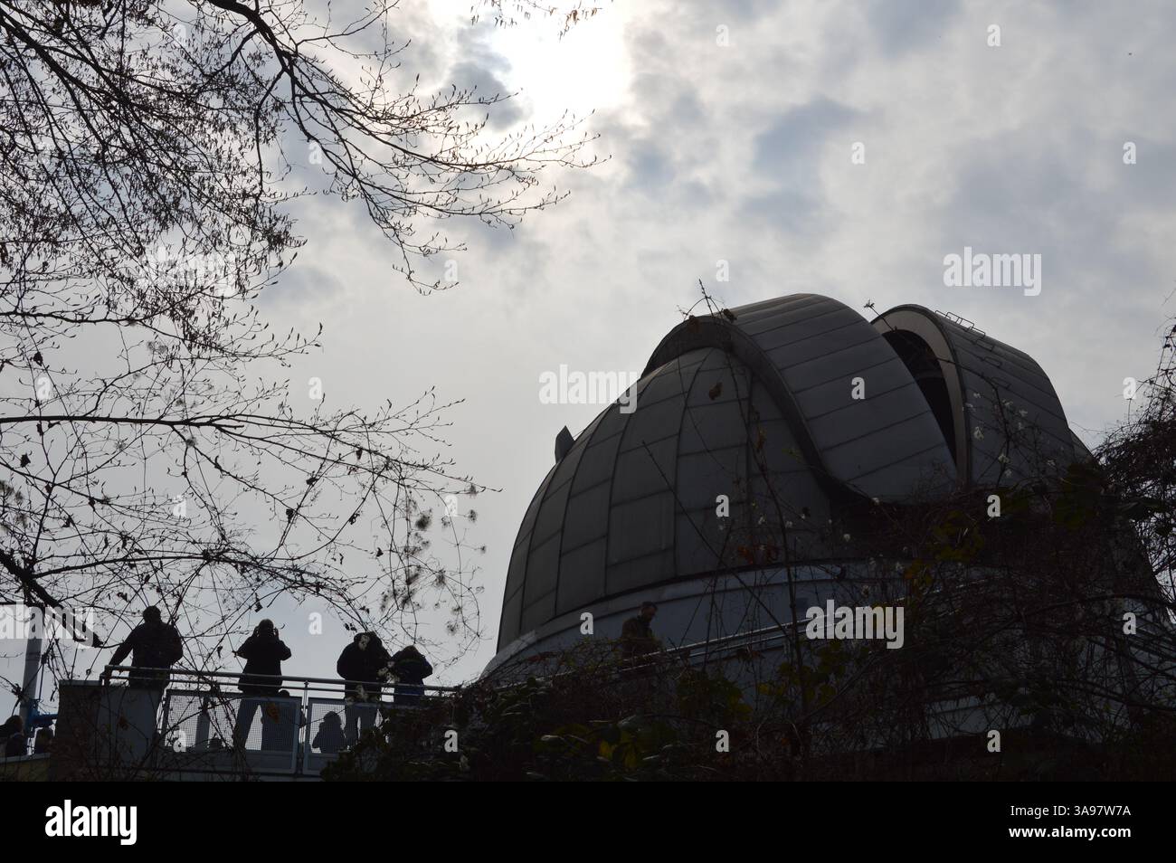 Berlin, Germany - March 28, 2025 - People watching a partial solar ...