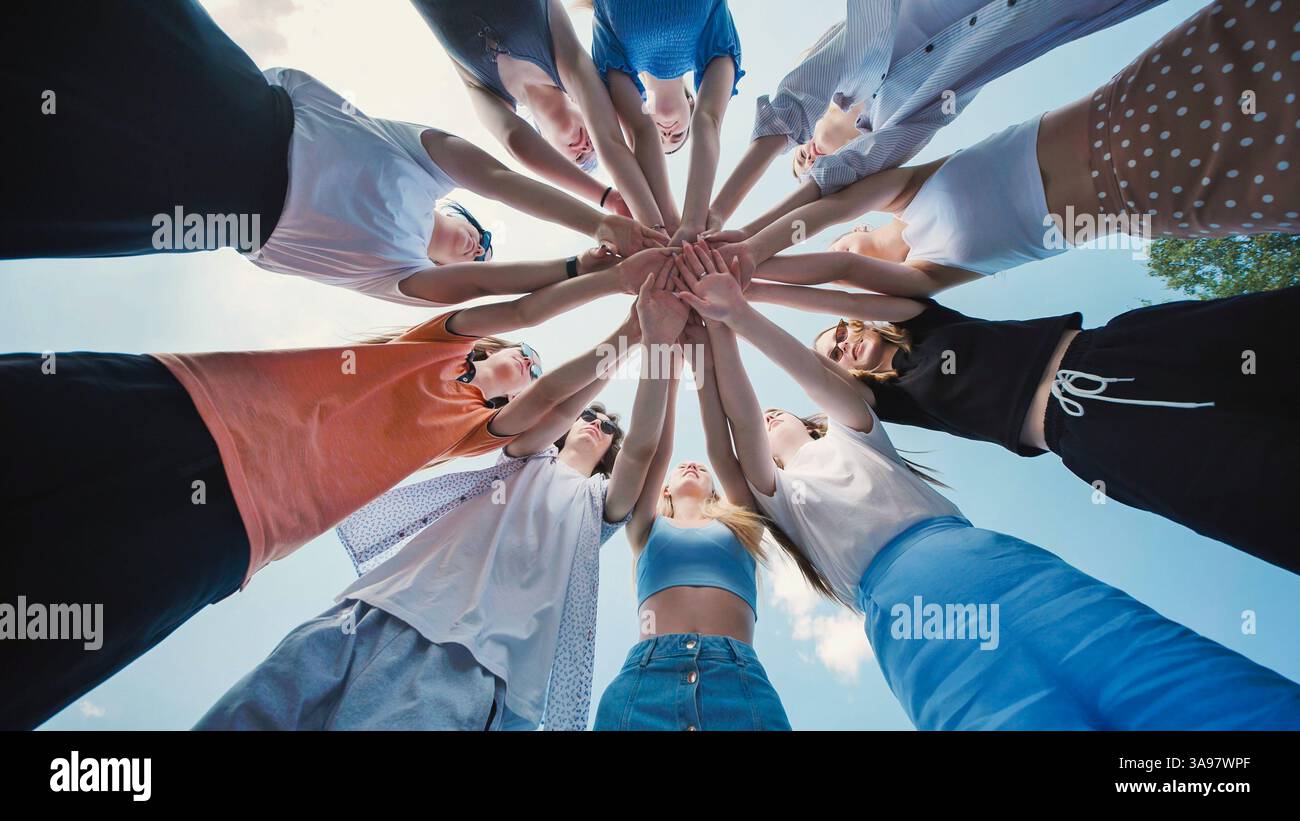 Young students uniting in a circle, representing teamwork, unity, and ...