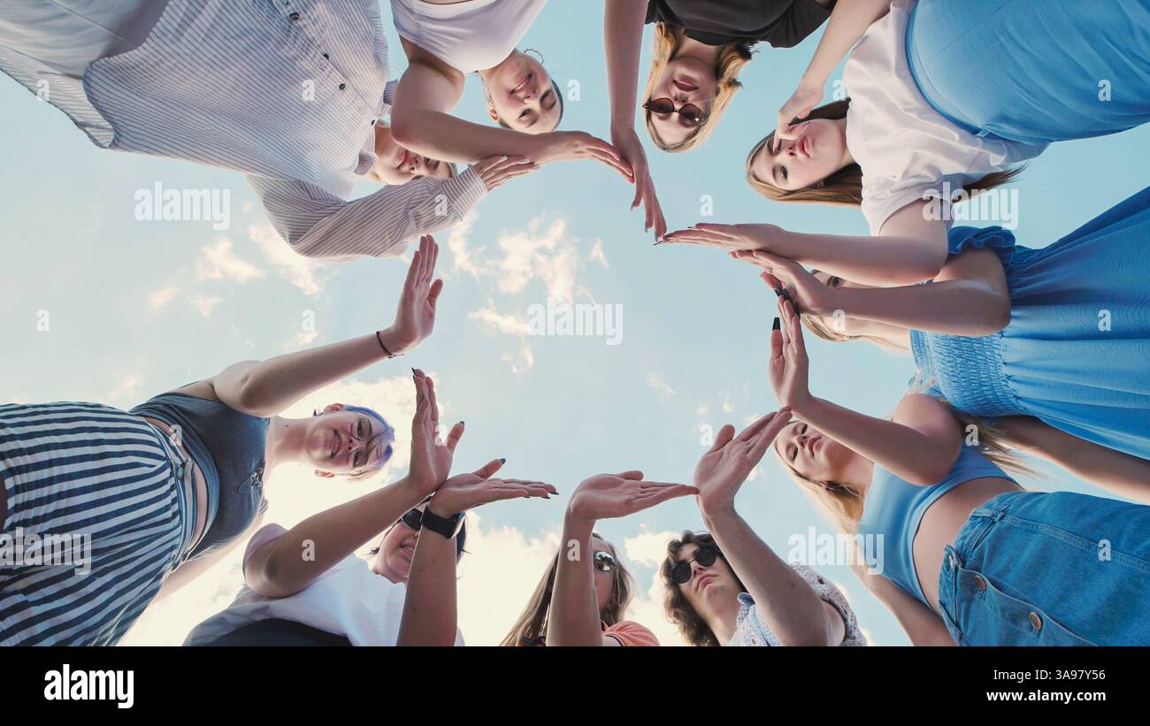School friends joining hands in a circle, representing unity, teamwork ...