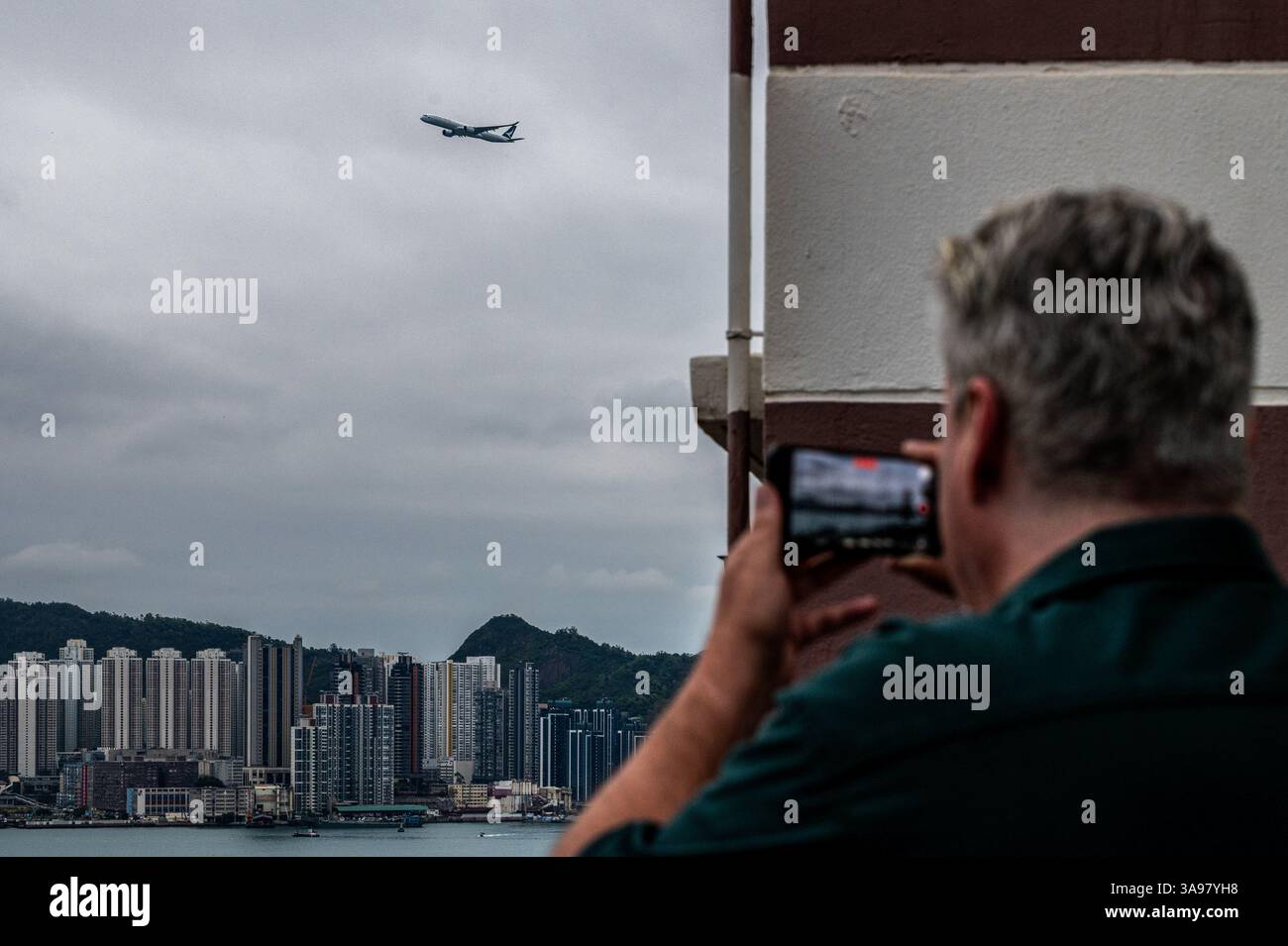 A spectator records the Cathay Pacific Airbus A350 as it performs a ...