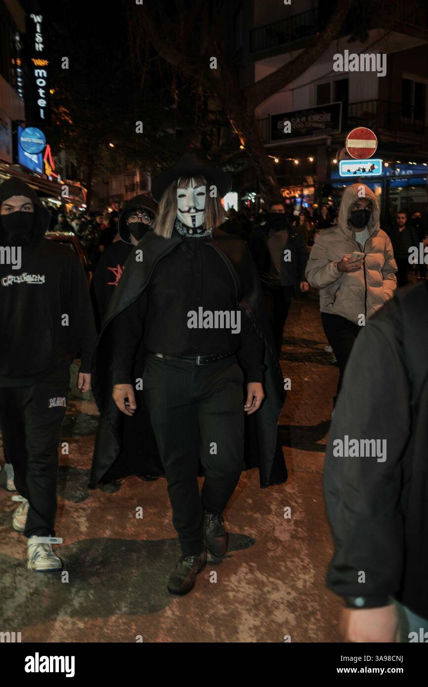 A protester dressed in a Vendetta suit during the protest. Young people ...