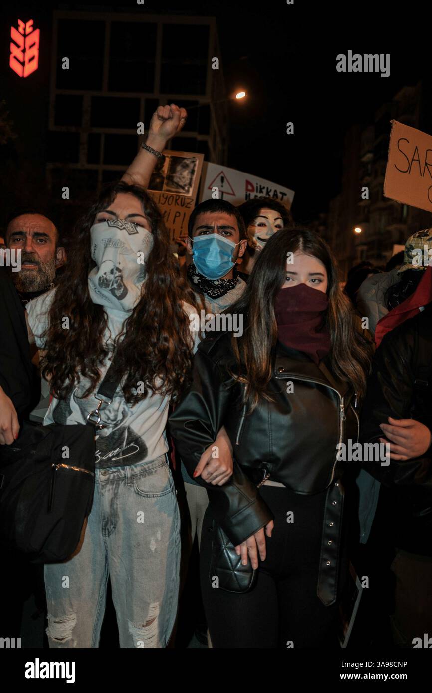 Protesters with their faces covered are shouting slogans during the ...