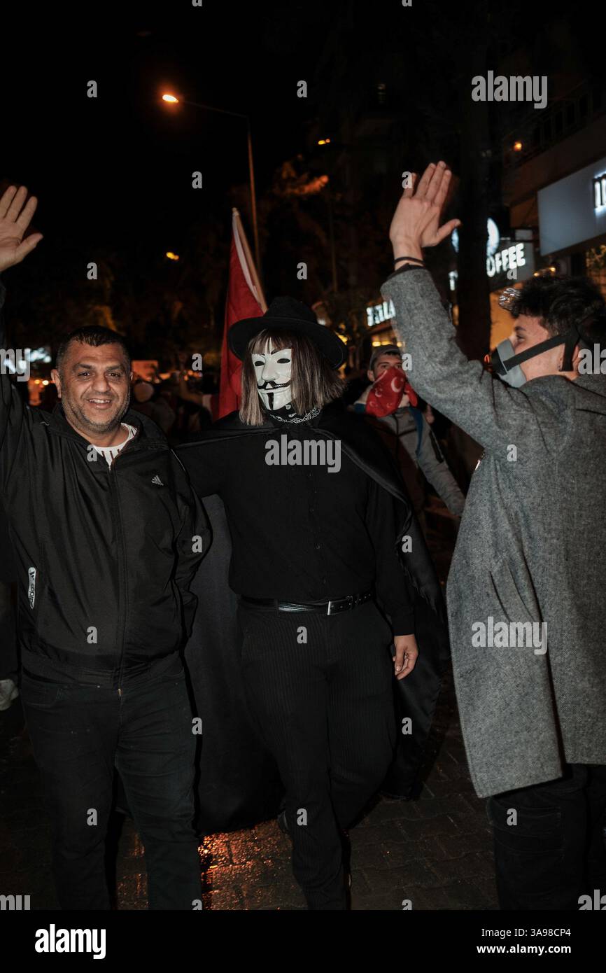 A protester dressed in a Vendetta suit during the protest. Young people ...
