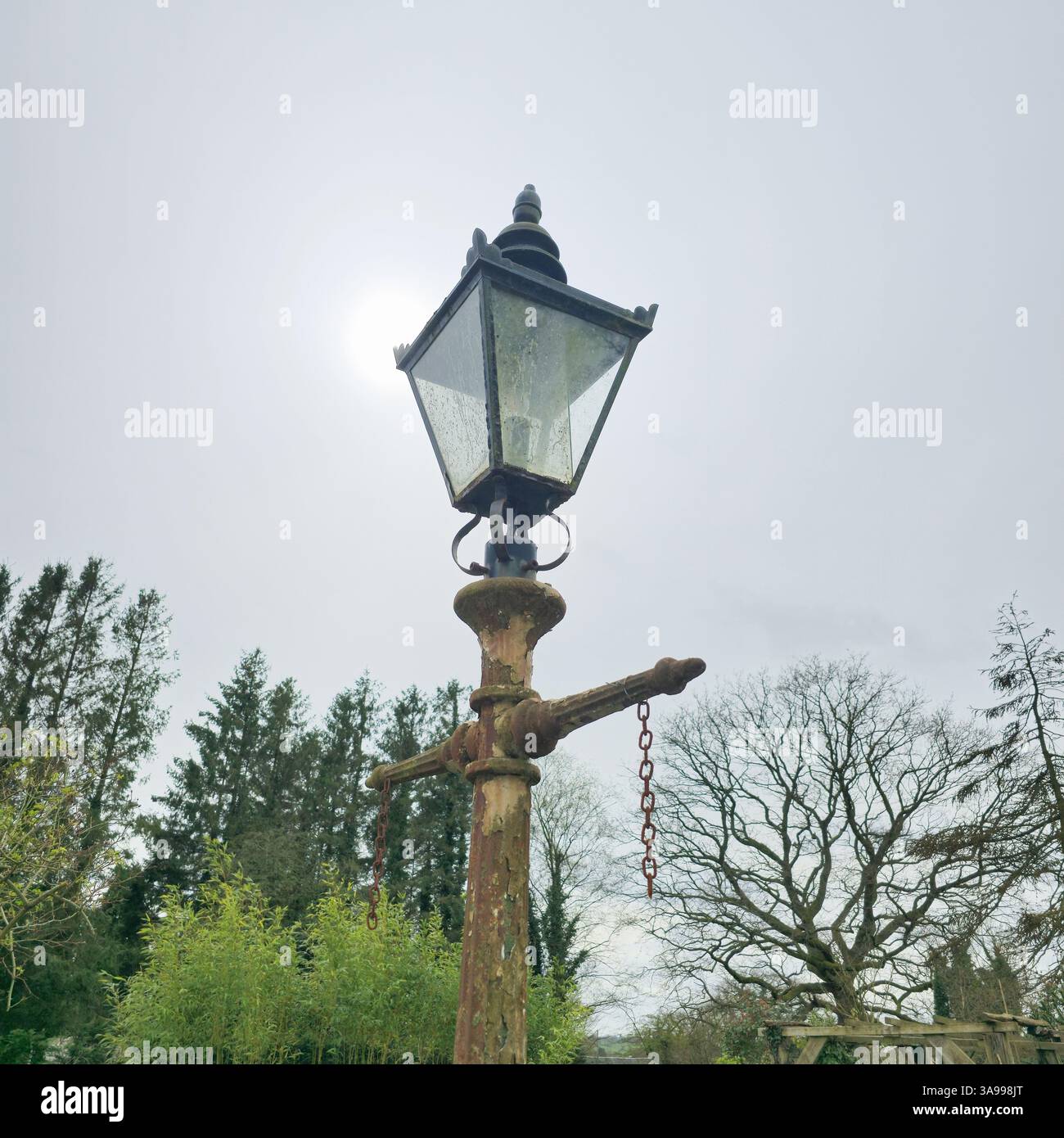 A melancholic photo of an old rusty Victorian street gas lamp made from ...